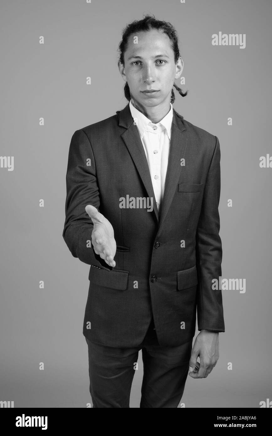 Young businessman with dreadlocks wearing suit in black and white Stock ...