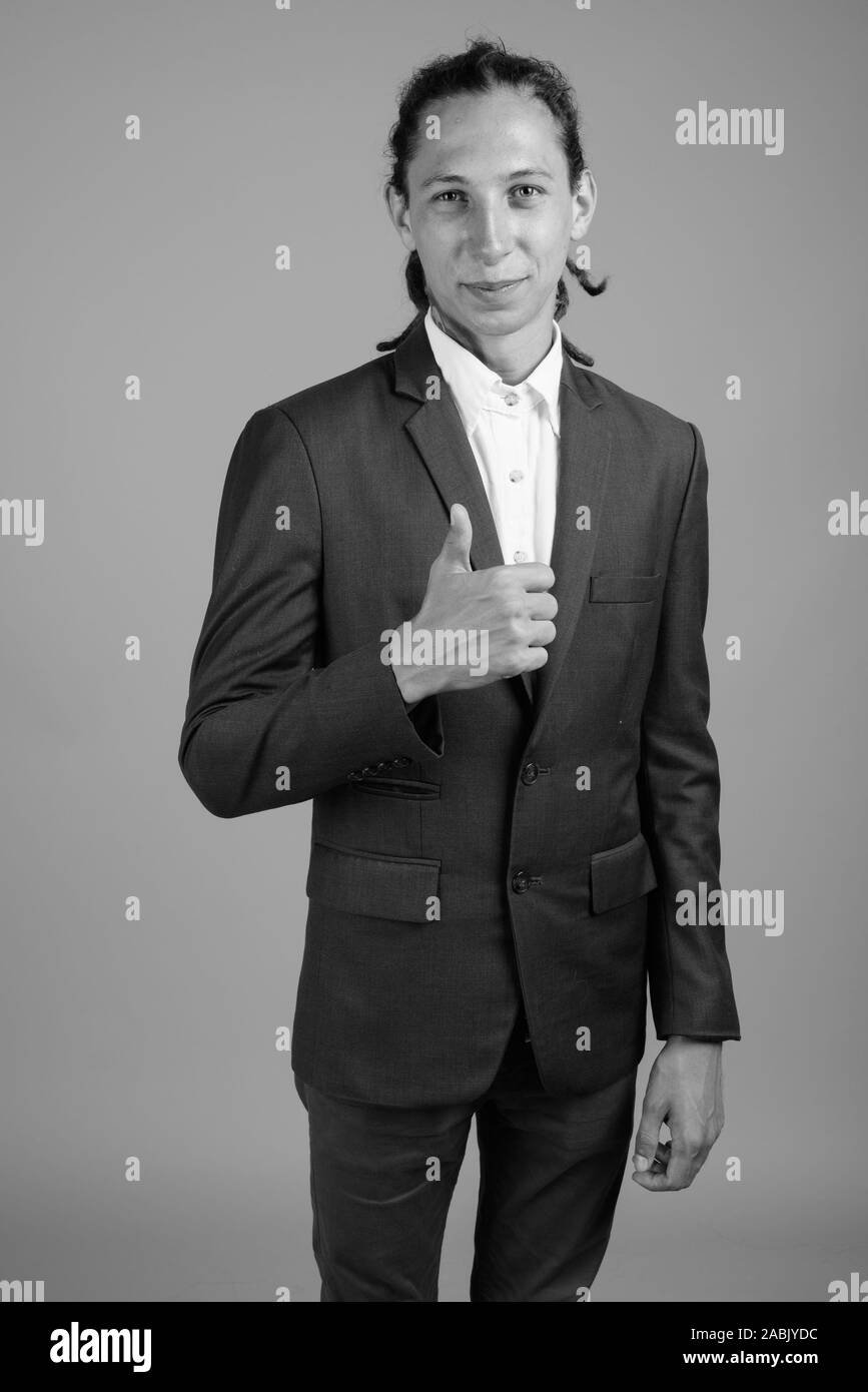 Young businessman with dreadlocks wearing suit in black and white Stock ...