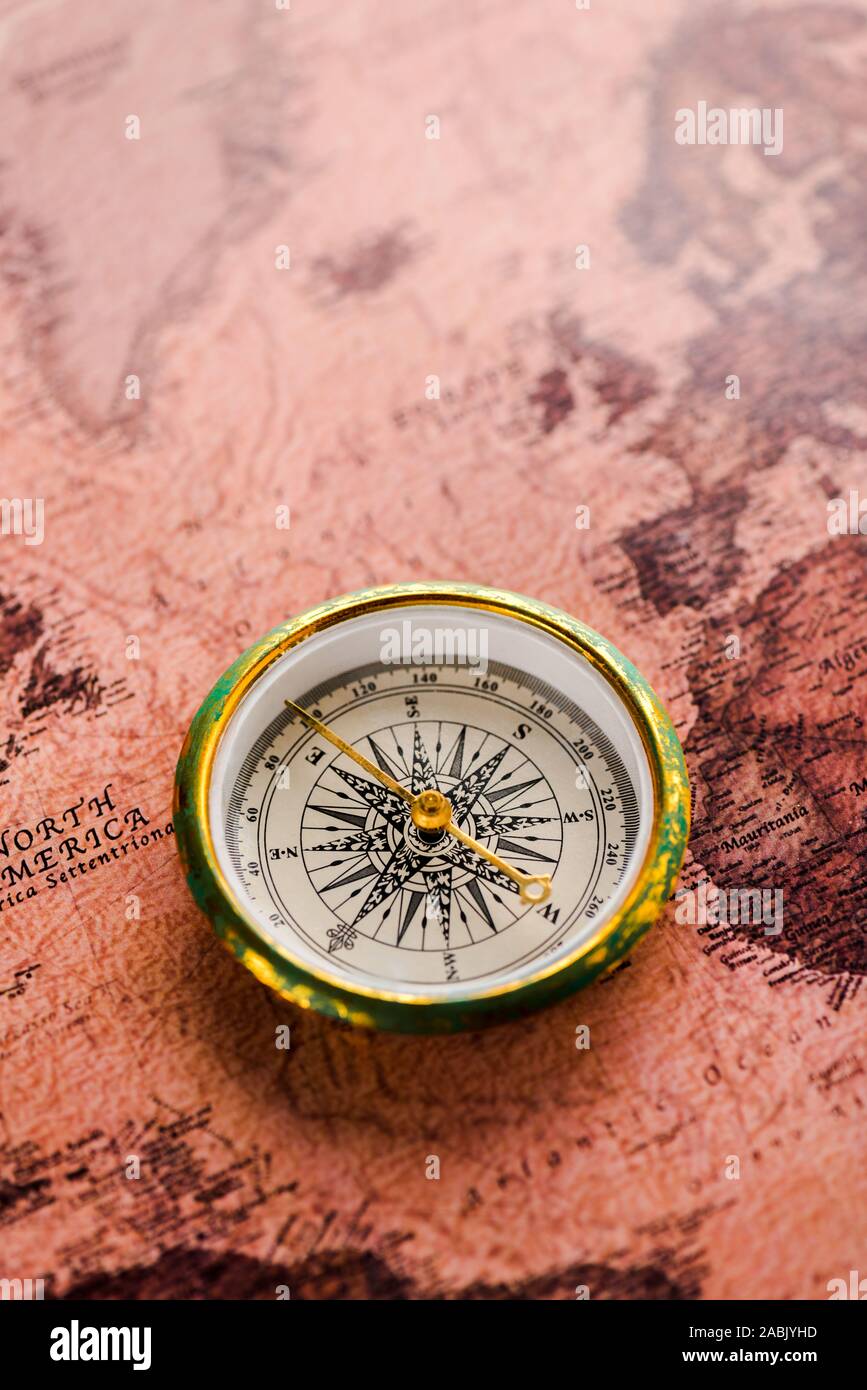 top view of golden compass on map Stock Photo - Alamy