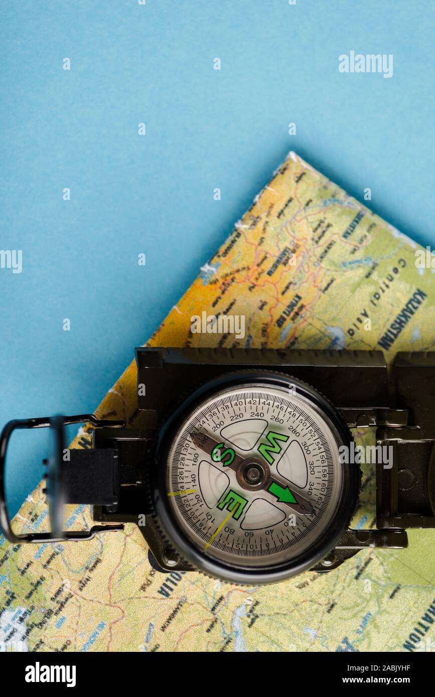 top view of retro and black compass on map on blue Stock Photo - Alamy