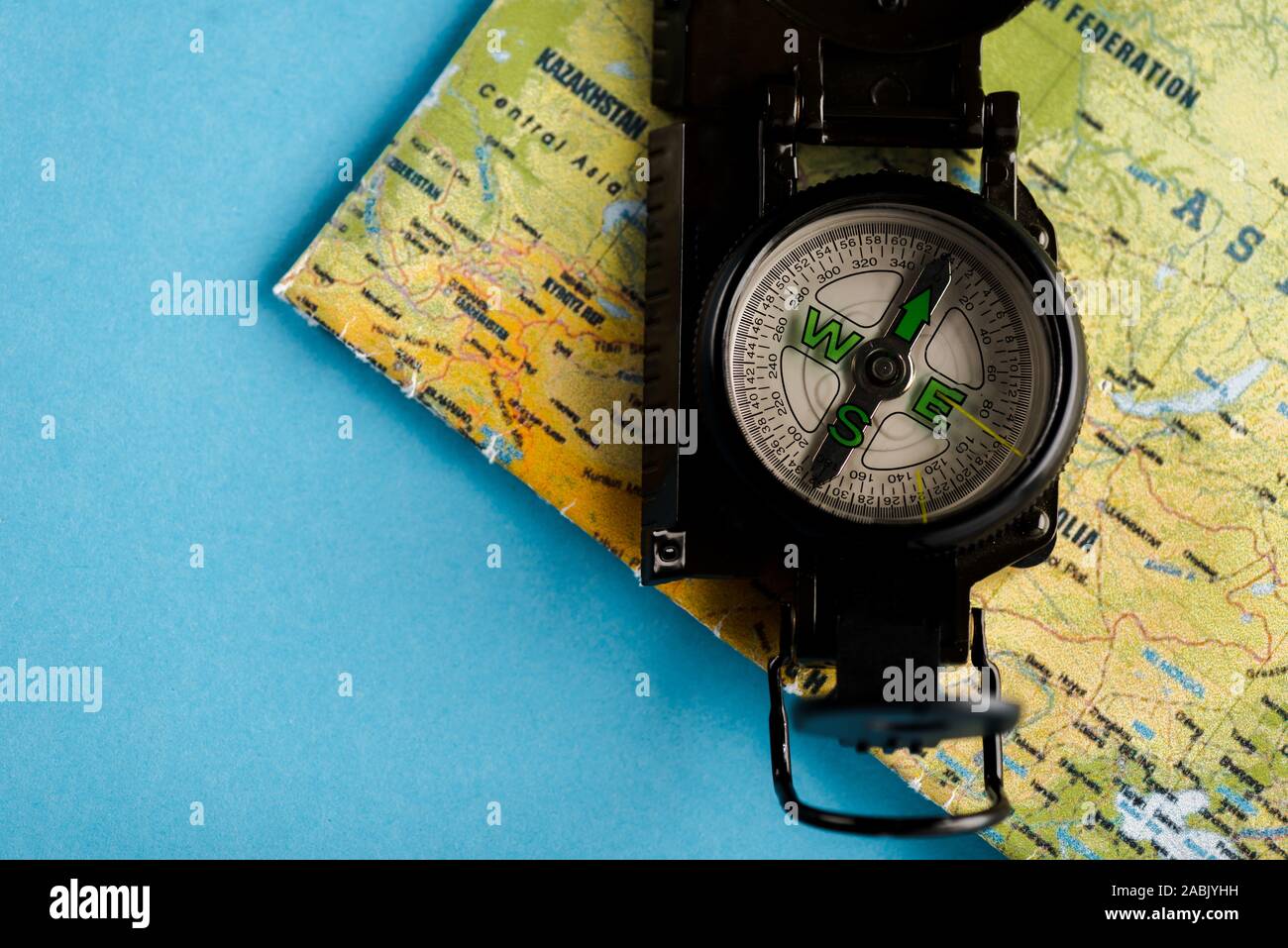 top view of black compass on map on blue Stock Photo - Alamy