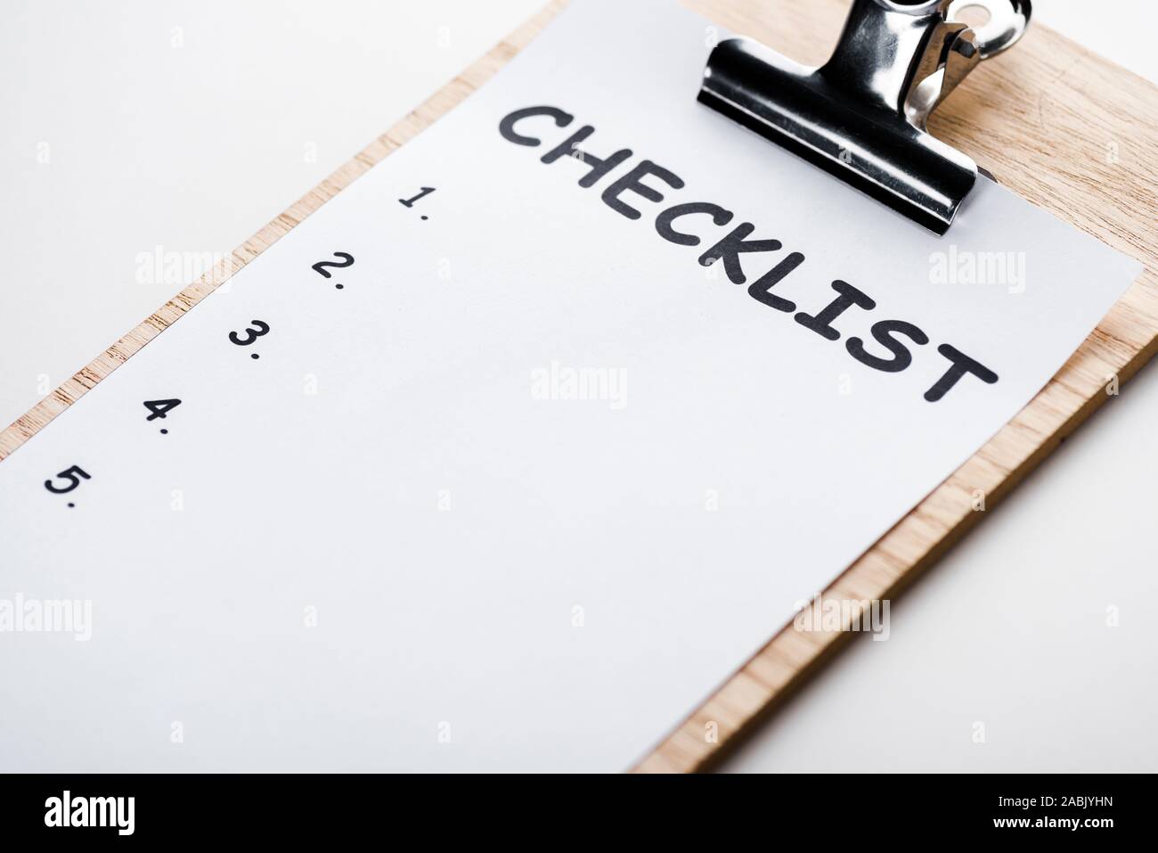 wooden clipboard with checklist lettering on paper isolated on white ...