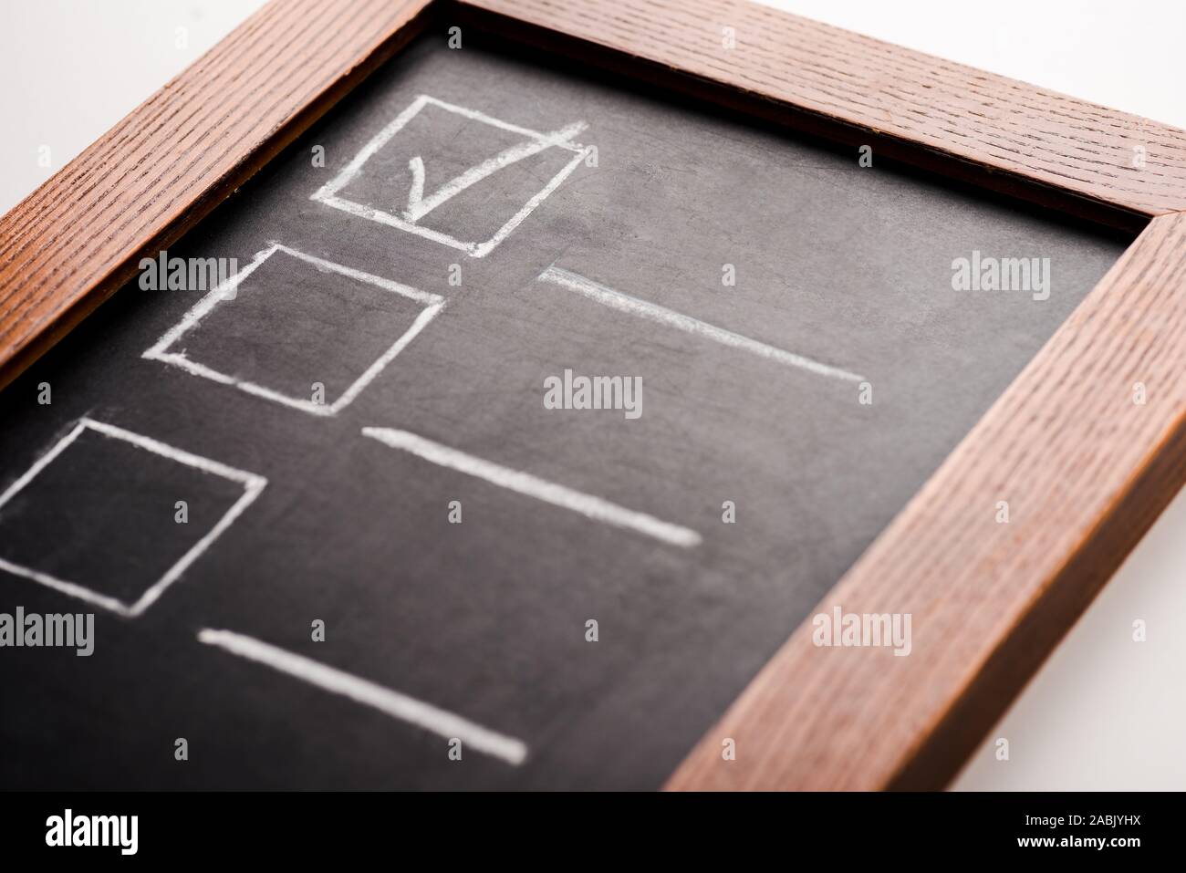close up of chalk board with tick in checklist isolated on white Stock ...