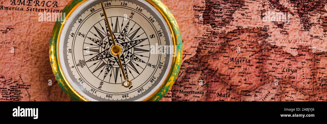 panoramic shot of golden compass near map Stock Photo - Alamy