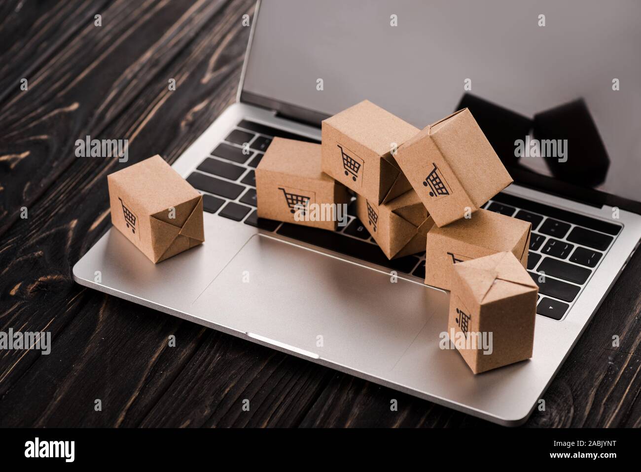small carton boxes on laptop with blank screen, e-commerce concept ...