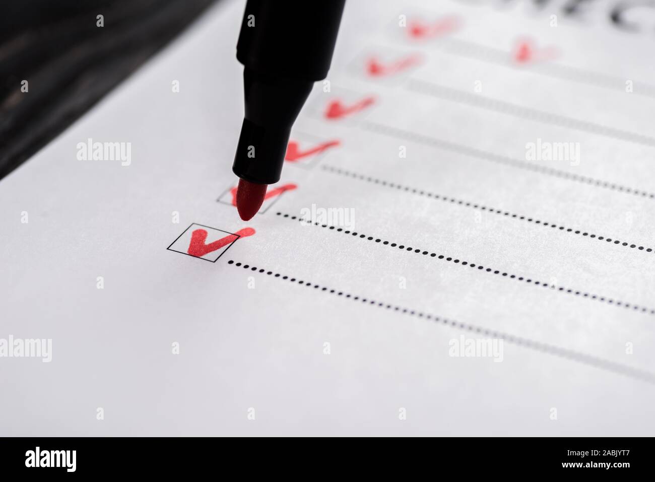 close up of checklist with ticks near red marker pen Stock Photo - Alamy