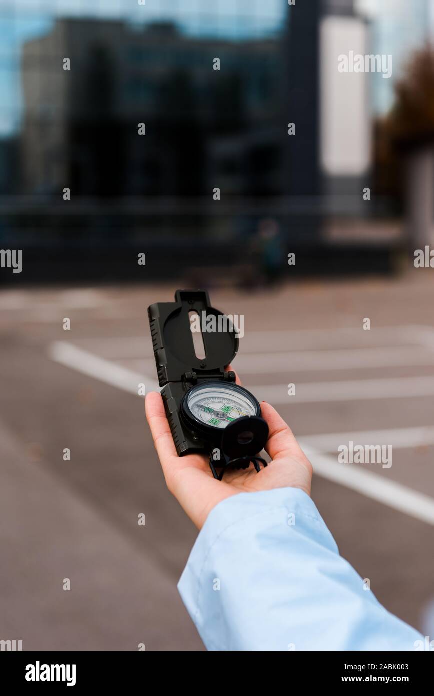 cropped view of woman holding compass outside Stock Photo - Alamy