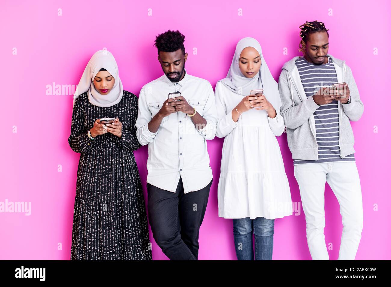 african students group using smart phones with plastic pink background ...
