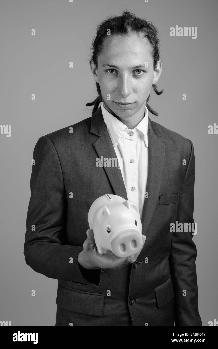 Young businessman with dreadlocks wearing suit in black and white Stock ...