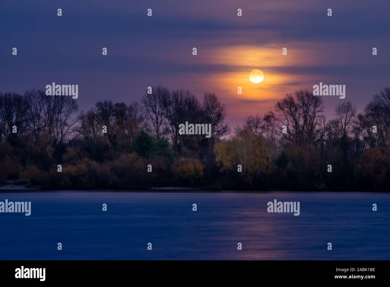 Real full moon over the autumn forest close to Dnieper river in Kiev ...