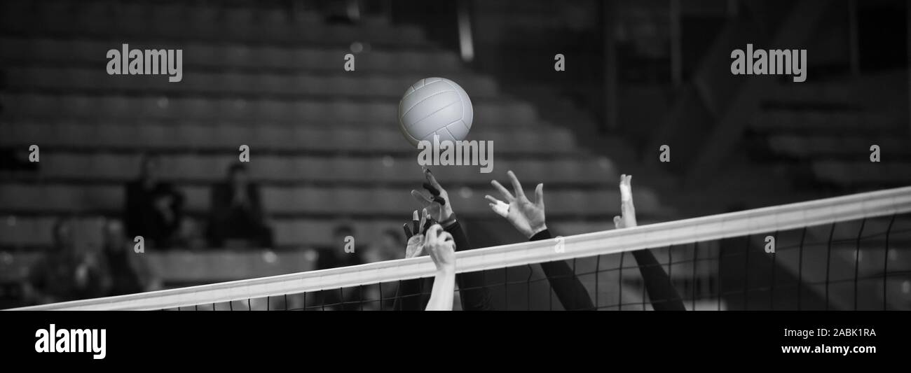 Girl Volleyball player and setter setting the ball for a spiker during ...
