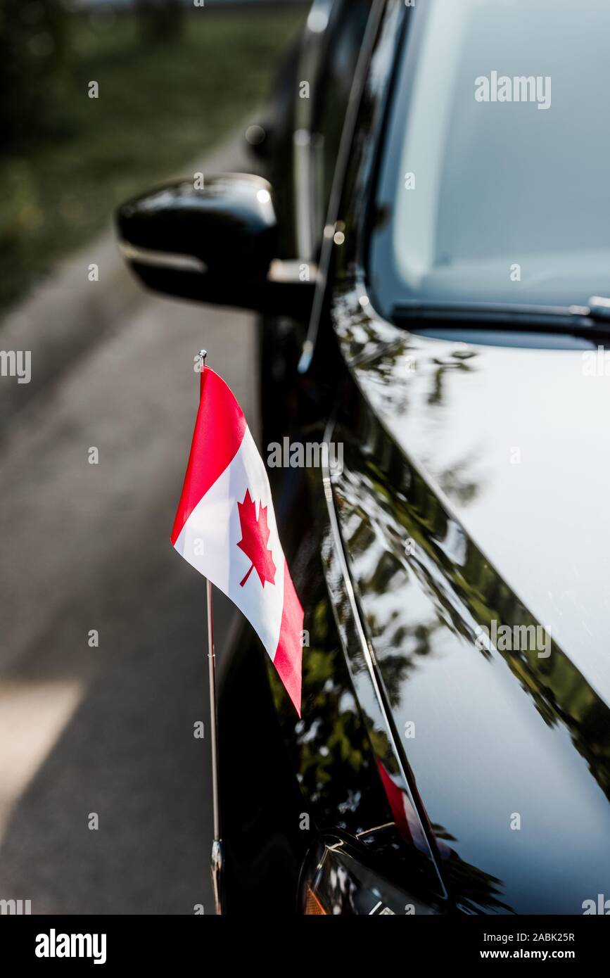 selective focus of canadian flag with maple leaf on modern car Stock ...