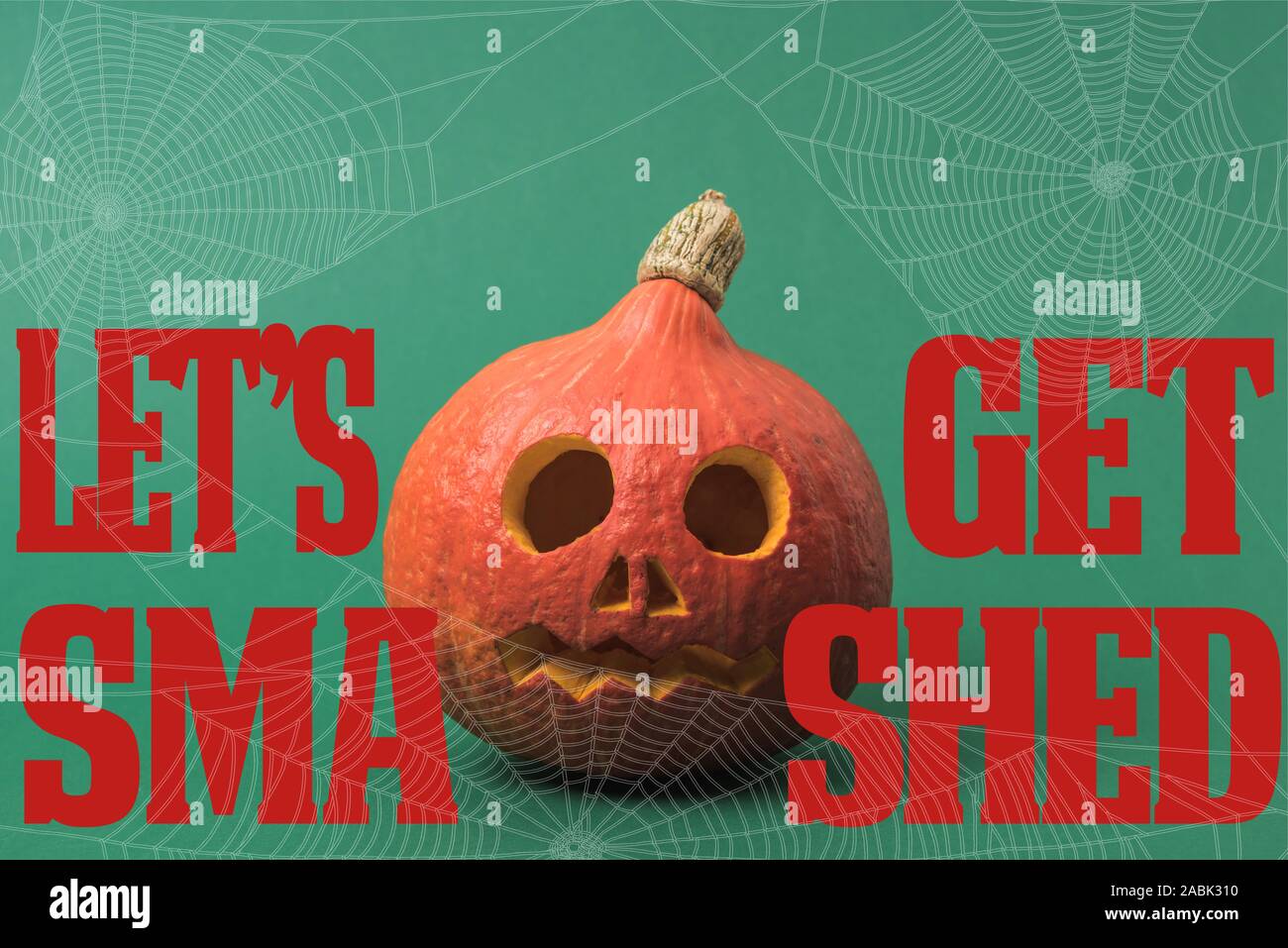 spooky Halloween pumpkin on green background with lets get smashed ...