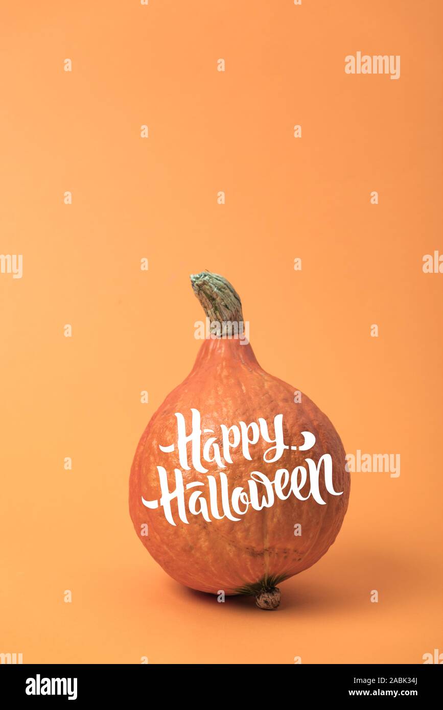 ripe Halloween pumpkin on orange background with happy Halloween ...