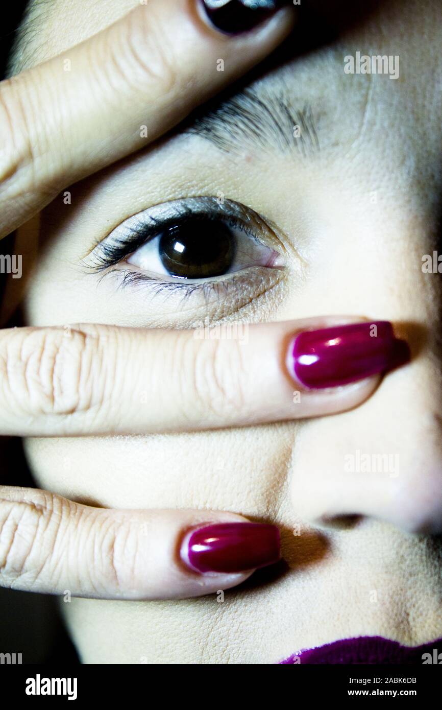 Portrait of woman with hand over face. Red makeup lips and nails Stock ...
