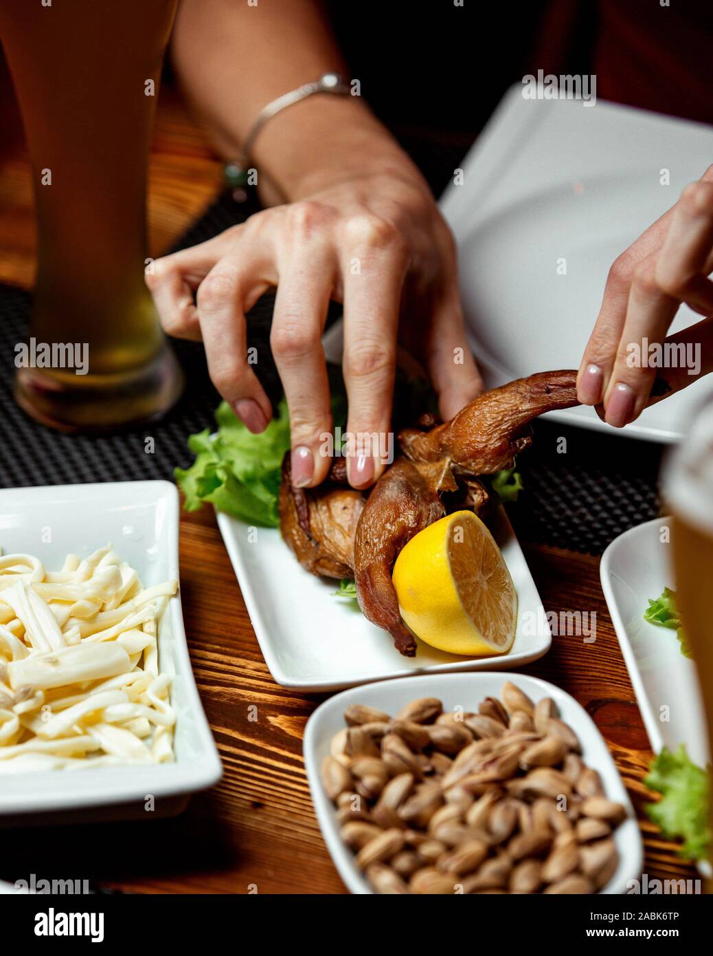 smoked quail served with lemon Stock Photo - Alamy