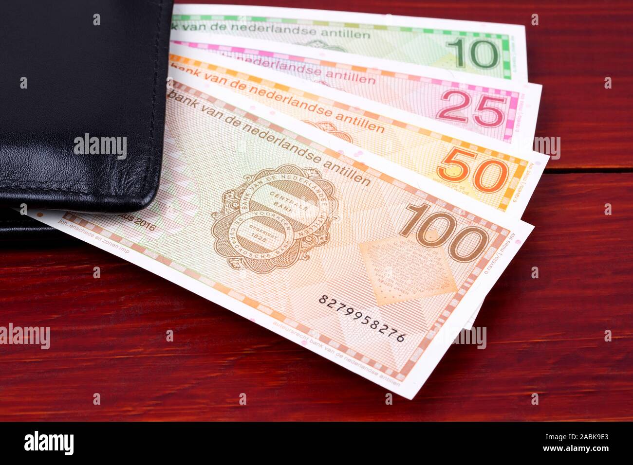 Netherlands Antillean money - Guilder in the black wallet Stock Photo ...