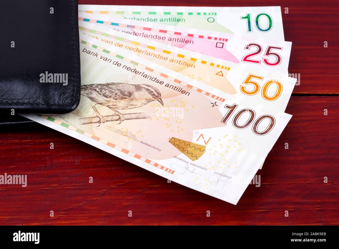 Netherlands Antillean money - Guilder in the black wallet Stock Photo ...