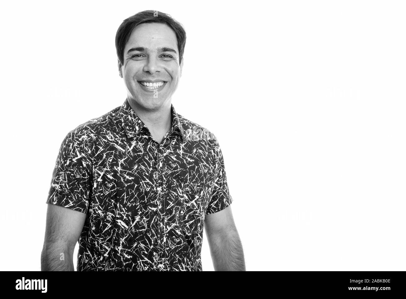 Studio shot of young happy Persian man smiling isolated against white ...
