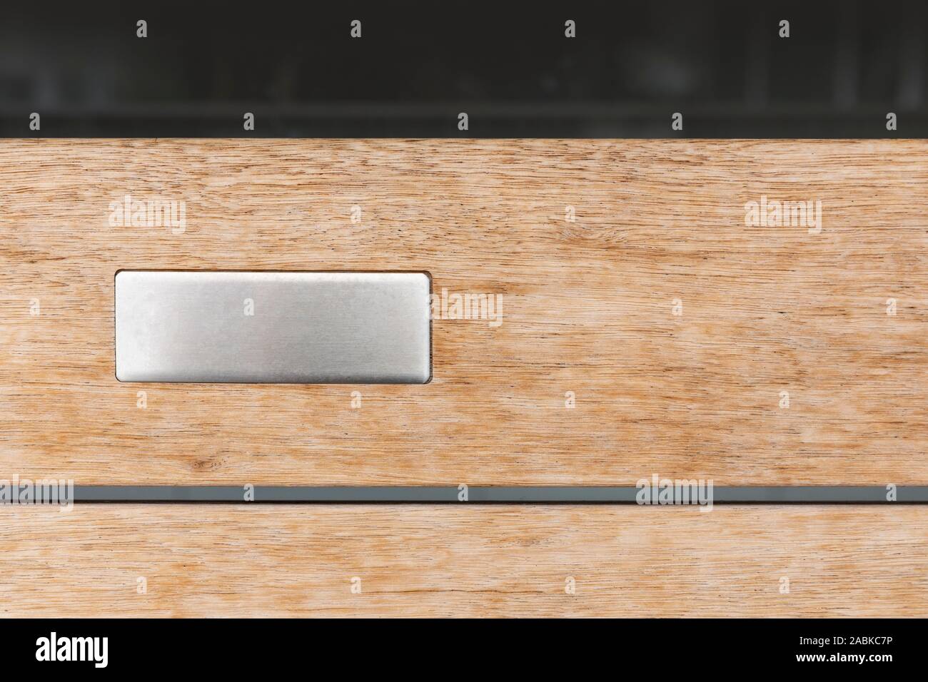 Detail of a metal name plate on the left with an empty space on a ...