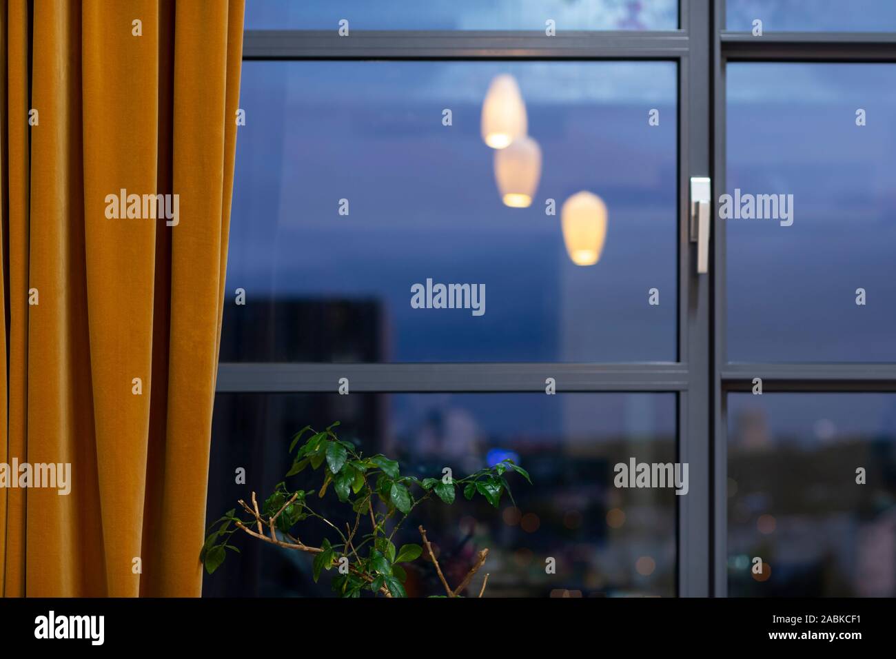 A view of the blurry skyline during sunset night, with an ochre yellow ...