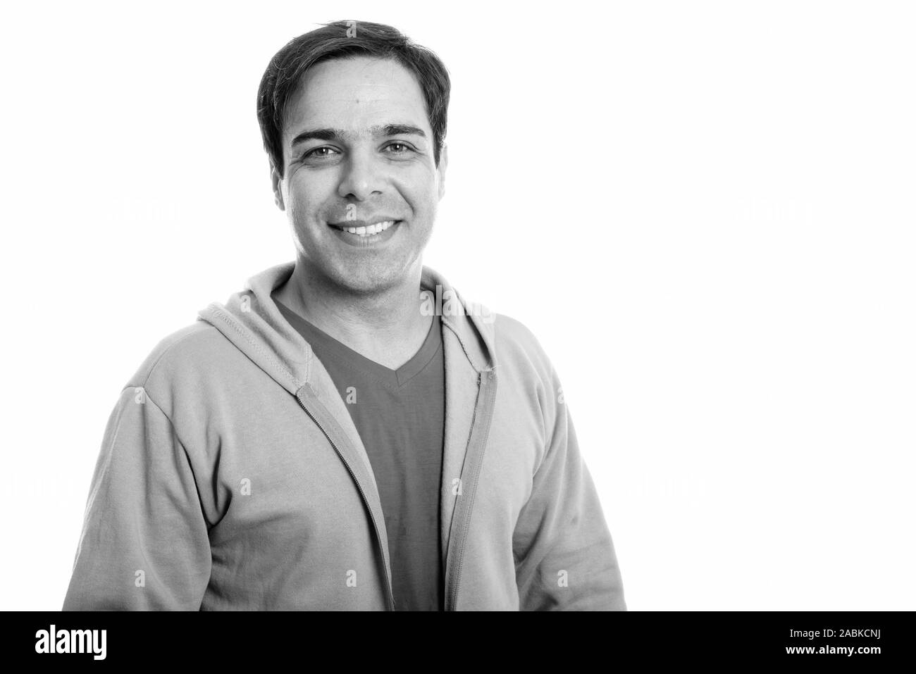 Close up of young happy Persian man smiling isolated against white ...