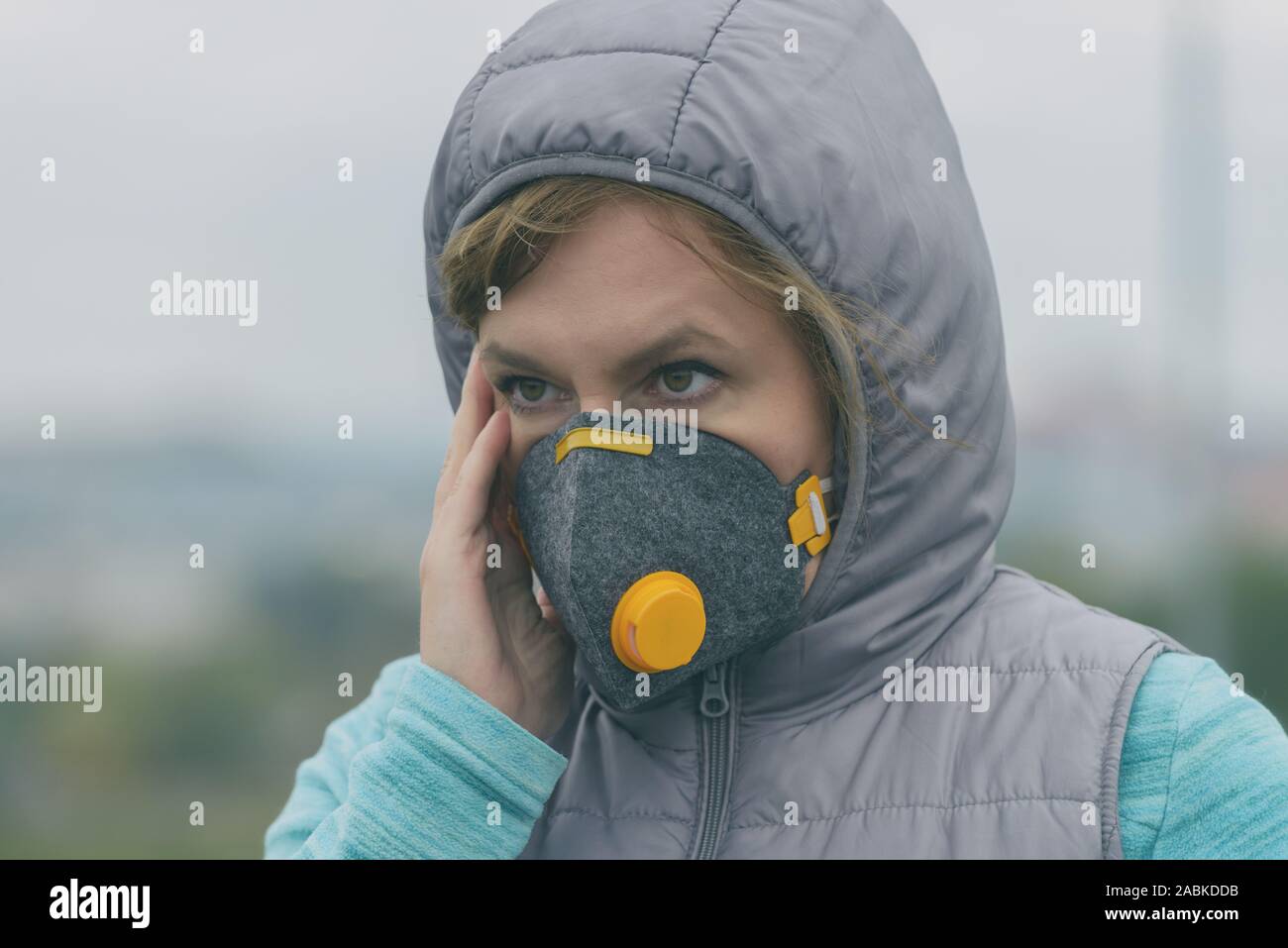 Woman wearing a real anti-pollution, anti-smog and viruses face mask ...