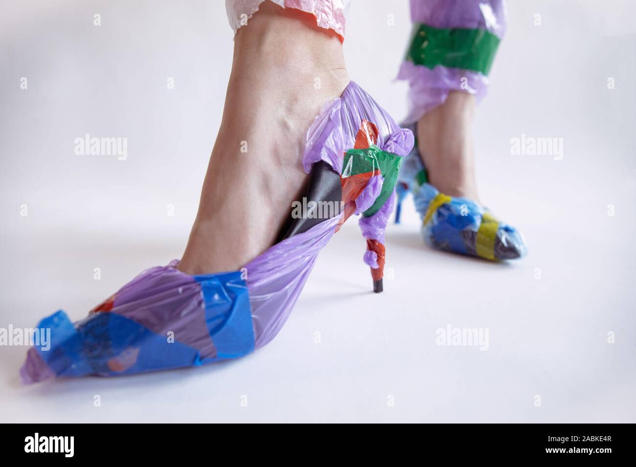 Close up of woman wearing plastic on white background. Female model in ...