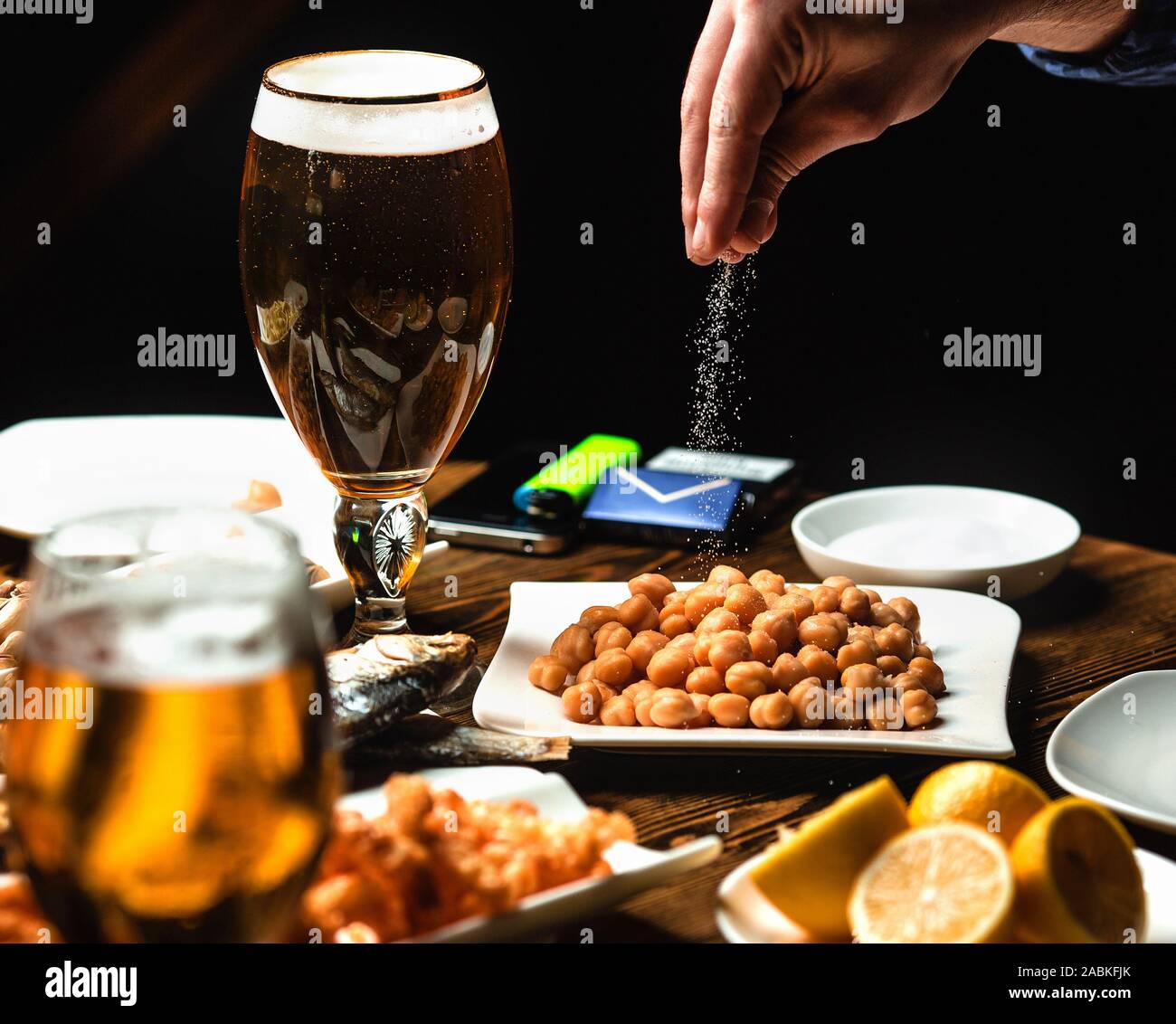 man pouring salt on boiled peas Stock Photo - Alamy