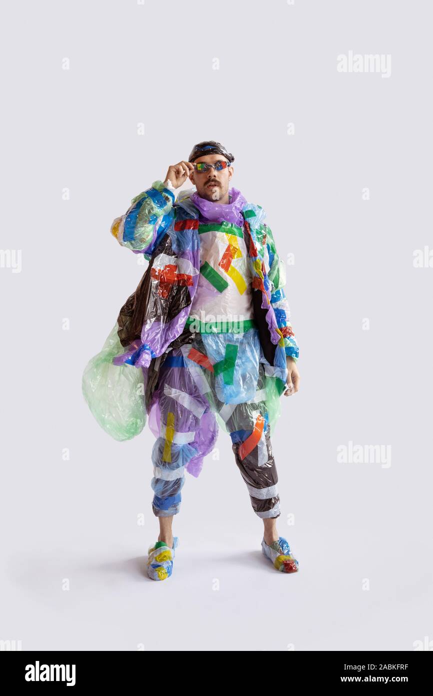 Man wearing plastic on white background. Male model in clothes made of ...