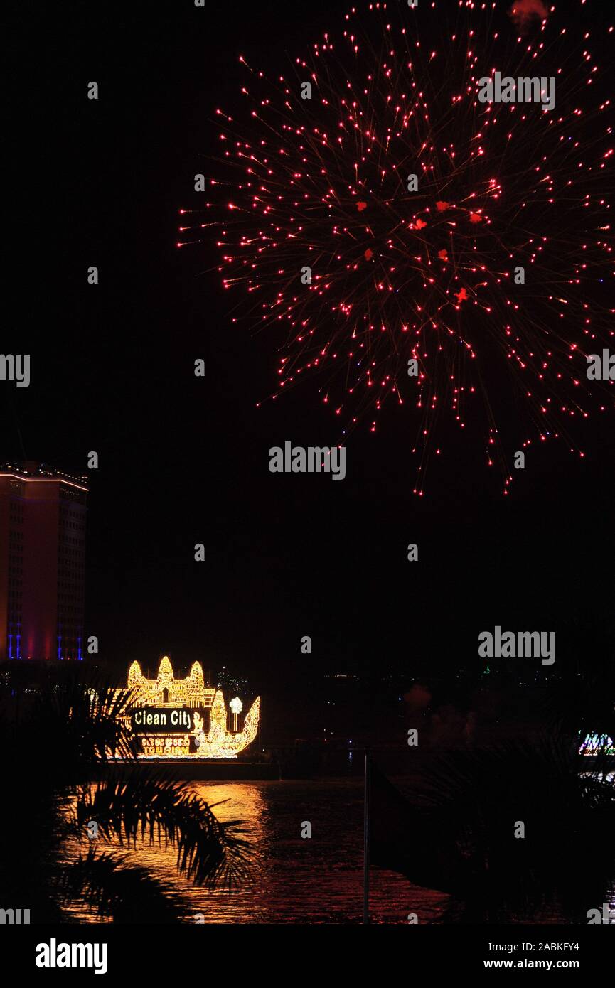 Fireworks exploding over an illuminated float on The Tonle Sap River ...