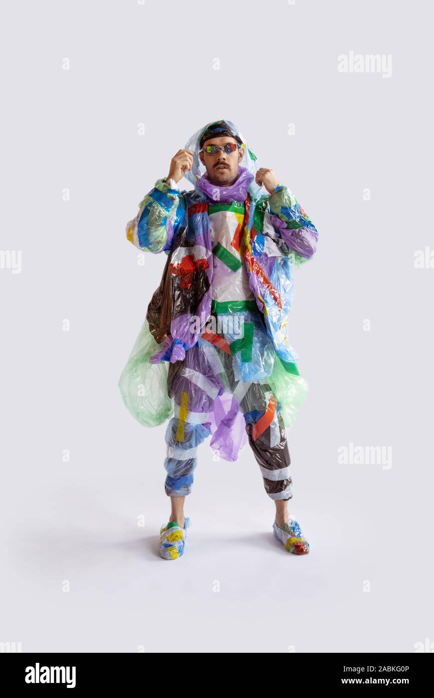 Man wearing plastic on white background. Male model in clothes made of ...