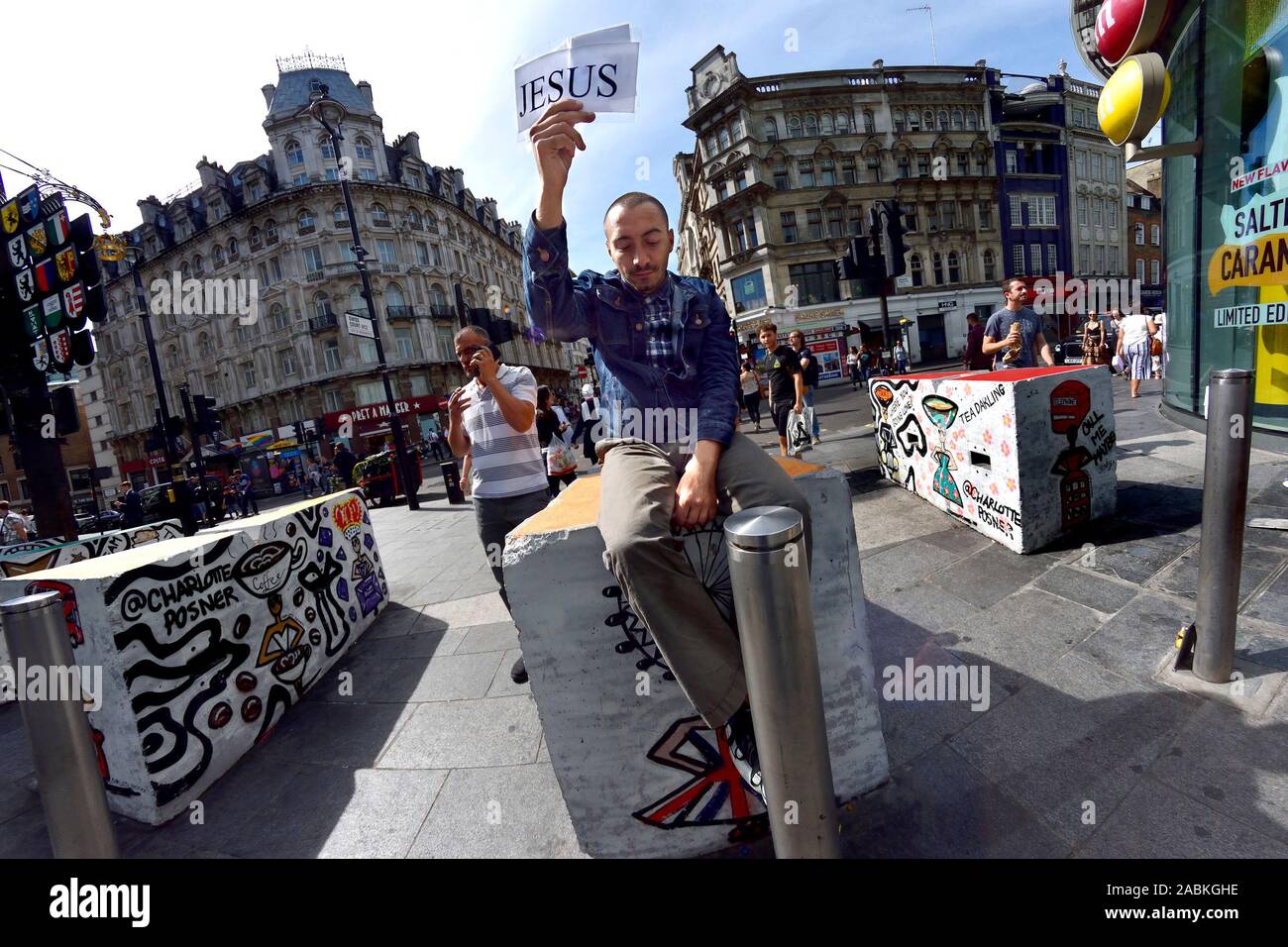 London, England, UK. Man in Leicester Square holding a piece of paper ...