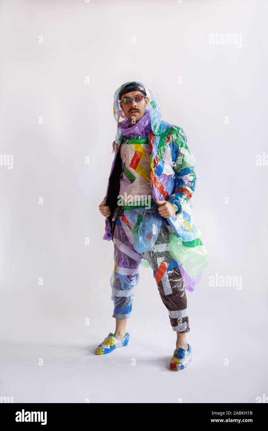 Man wearing plastic on white background. Male model in clothes made of ...