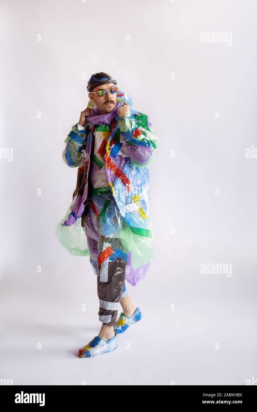 Man wearing plastic on white background. Male model in clothes made of ...