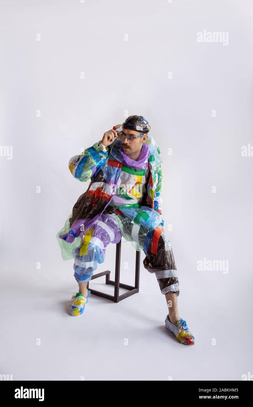 Man wearing plastic on white background. Male model in clothes made of ...