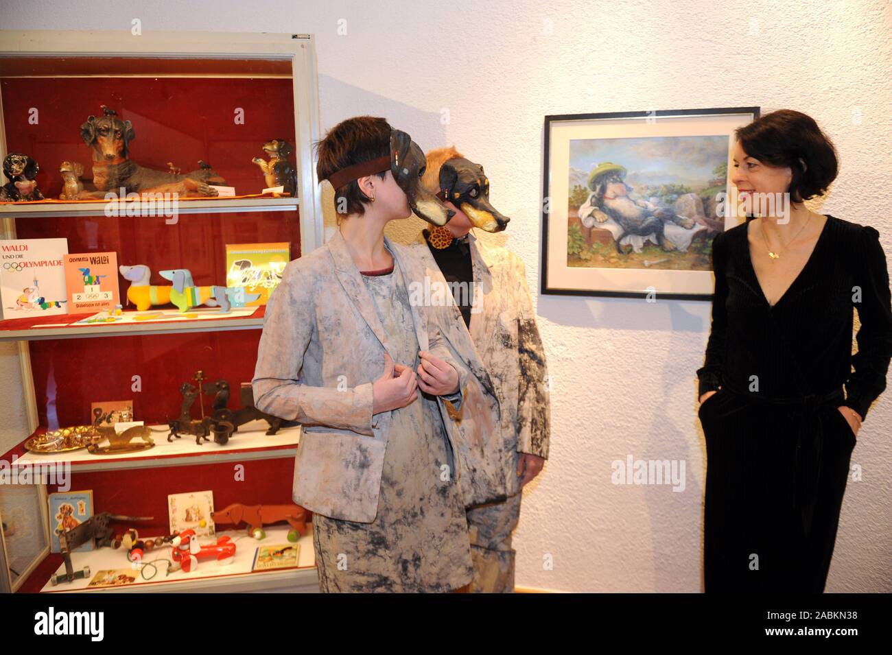 Museum director Sabine Rinberger next to two people in a dachshund ...