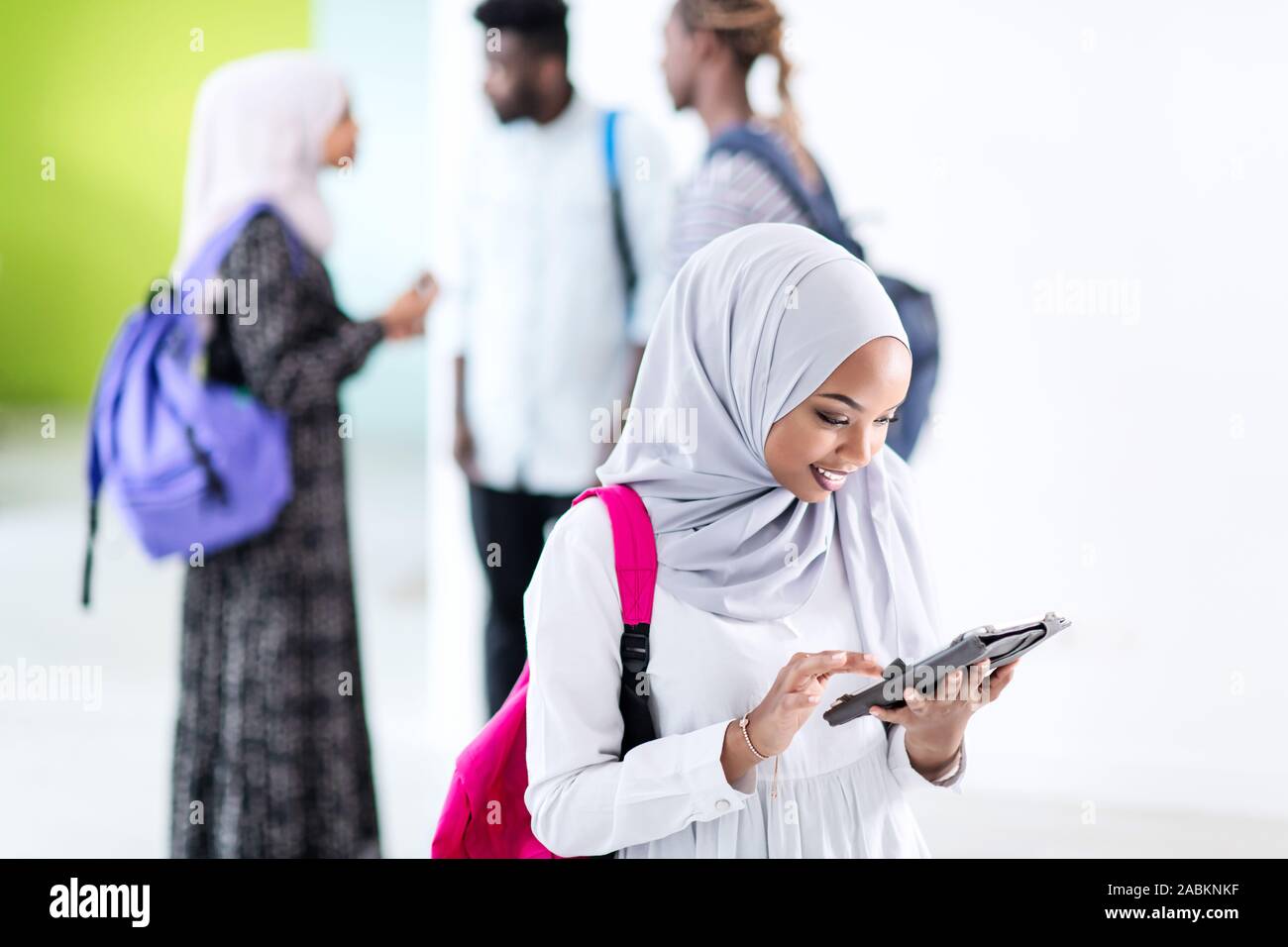 young modern muslim african female student using tablet computer with ...