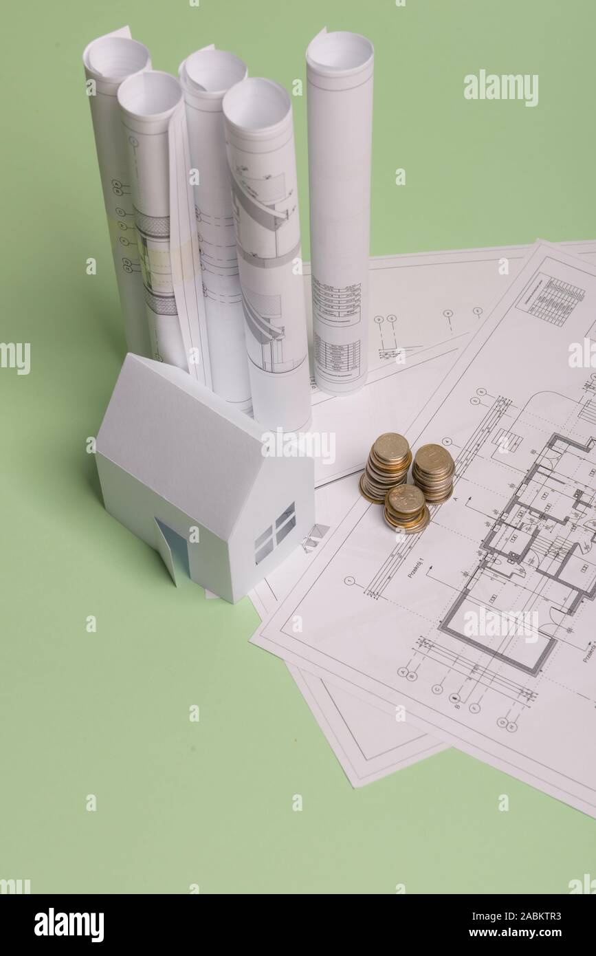 White family paper house , stack of money coins, house projects plan ...