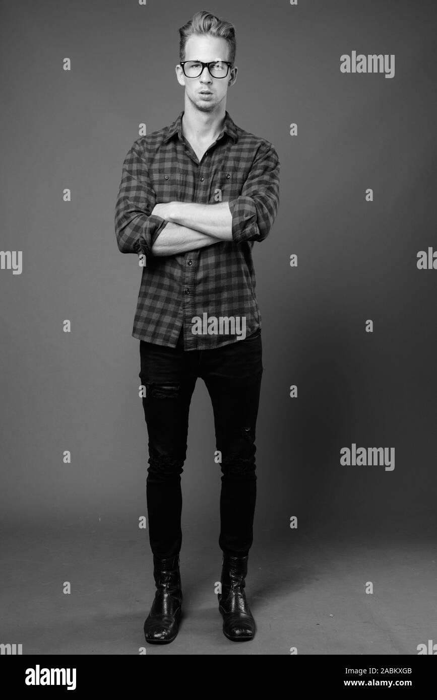 Studio shot of young handsome hipster man in black and white Stock ...