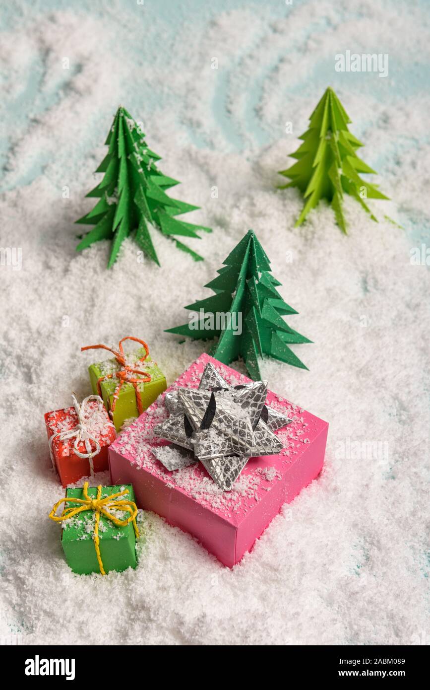 christmas presents nicely decorated with bows and feathers in snow ...
