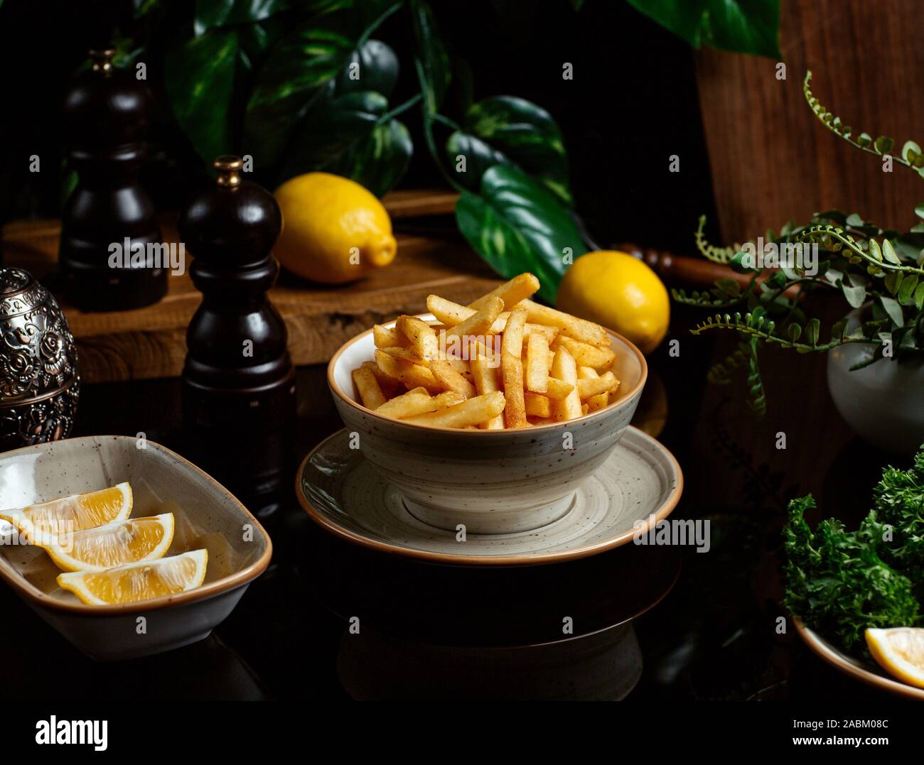 french fries with sliced lemon Stock Photo - Alamy