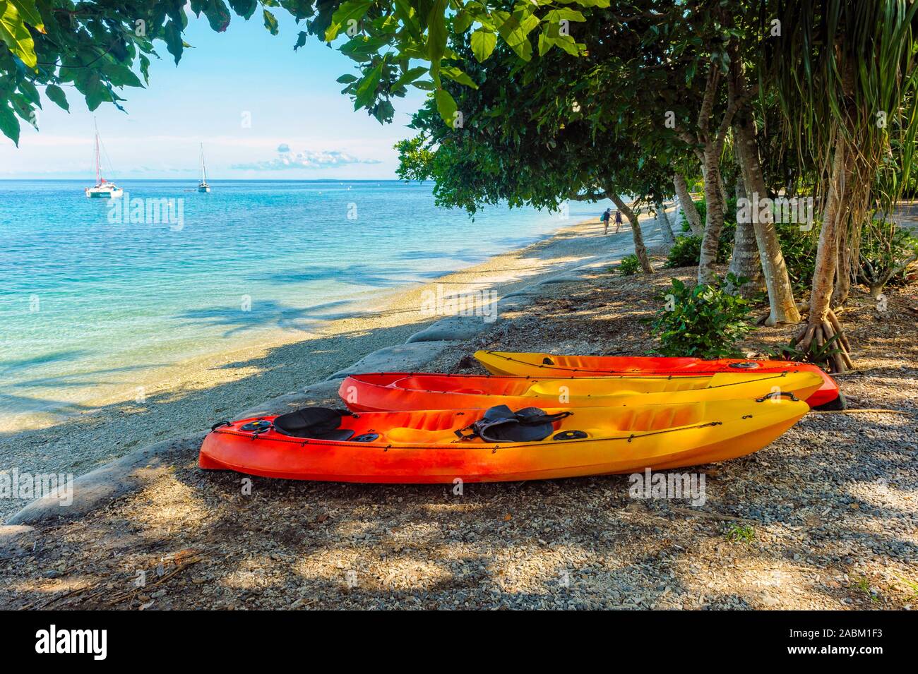 Three colorful kayaks on a Tropical Beach Stock Photo - Alamy
