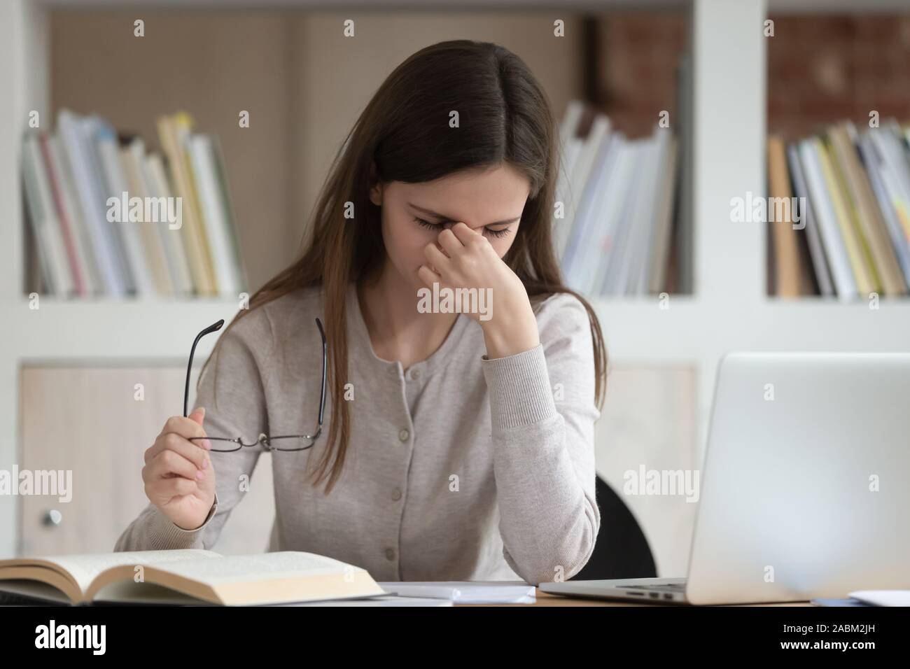 Overload young girl feeling fatigue, taking off glasses Stock Photo - Alamy