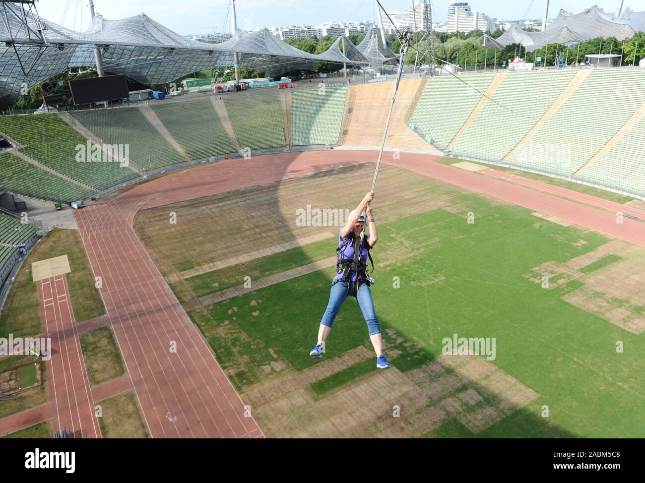 Stadium visitor during a ride with the Flying Fox rope slide over the ...