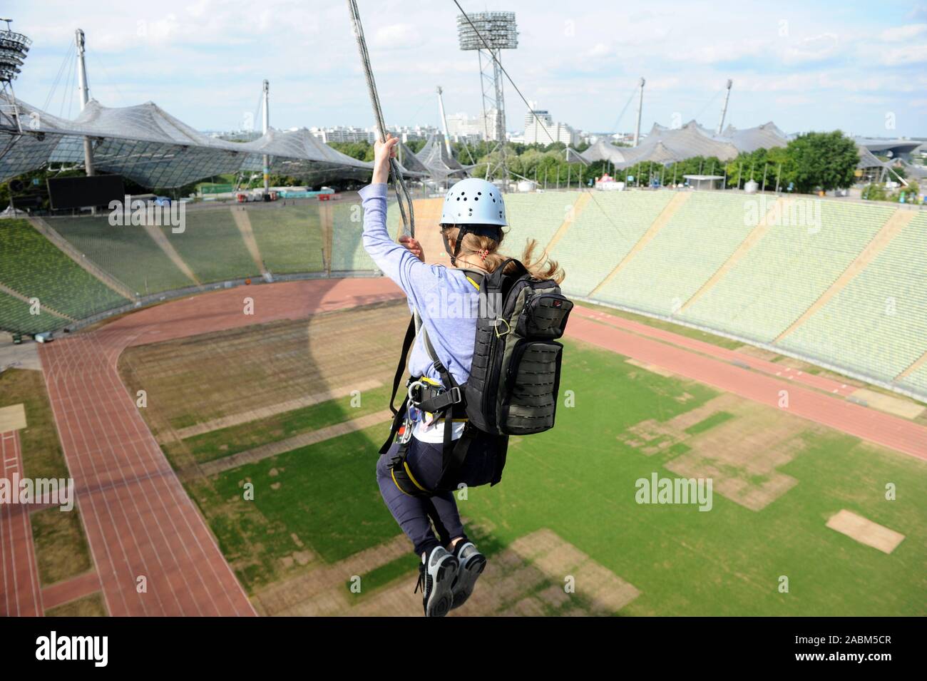 Stadium visitor during a ride with the Flying Fox rope slide over the ...