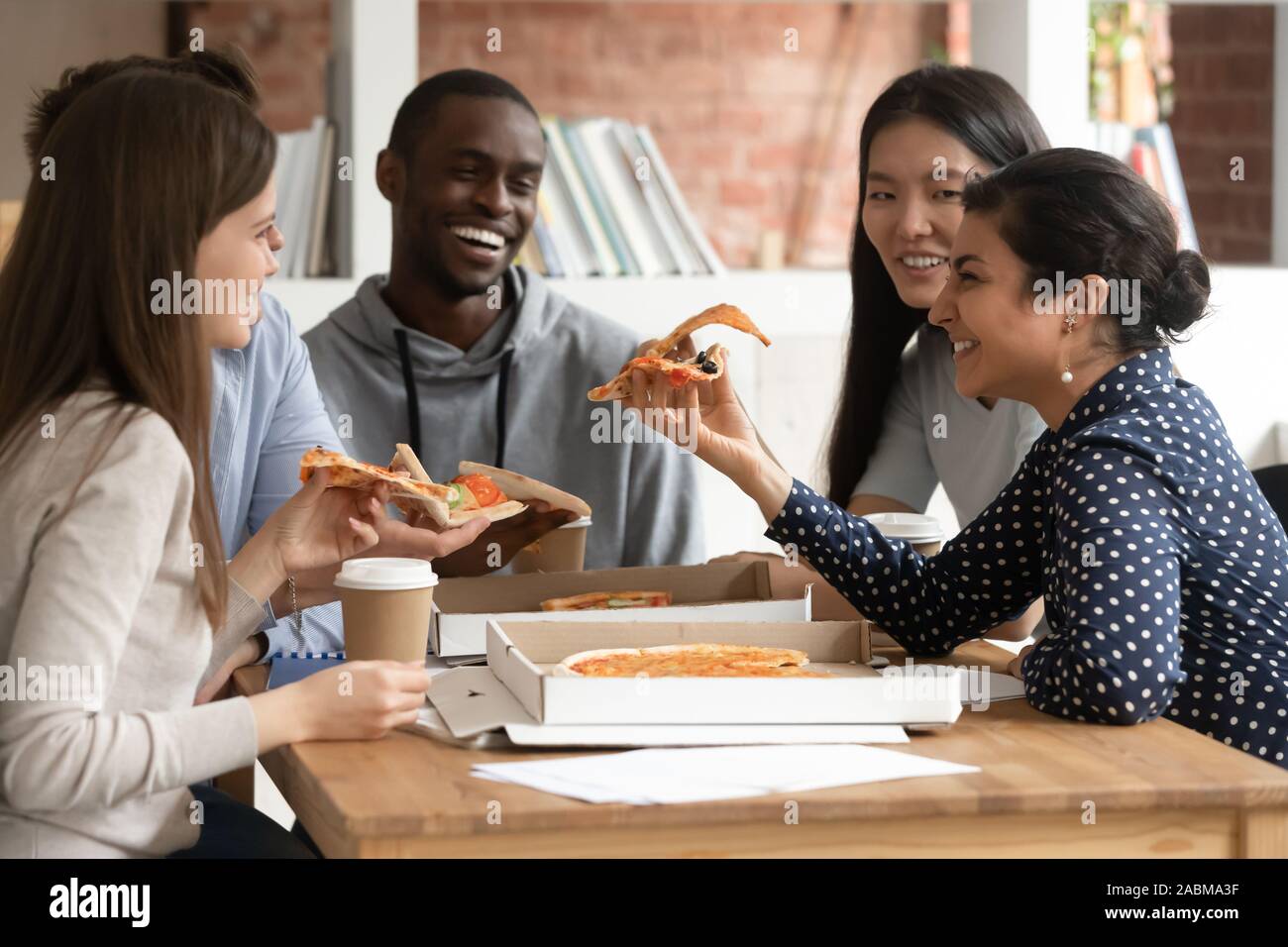 Overjoyed young indian female student laughing during lunch time Stock ...