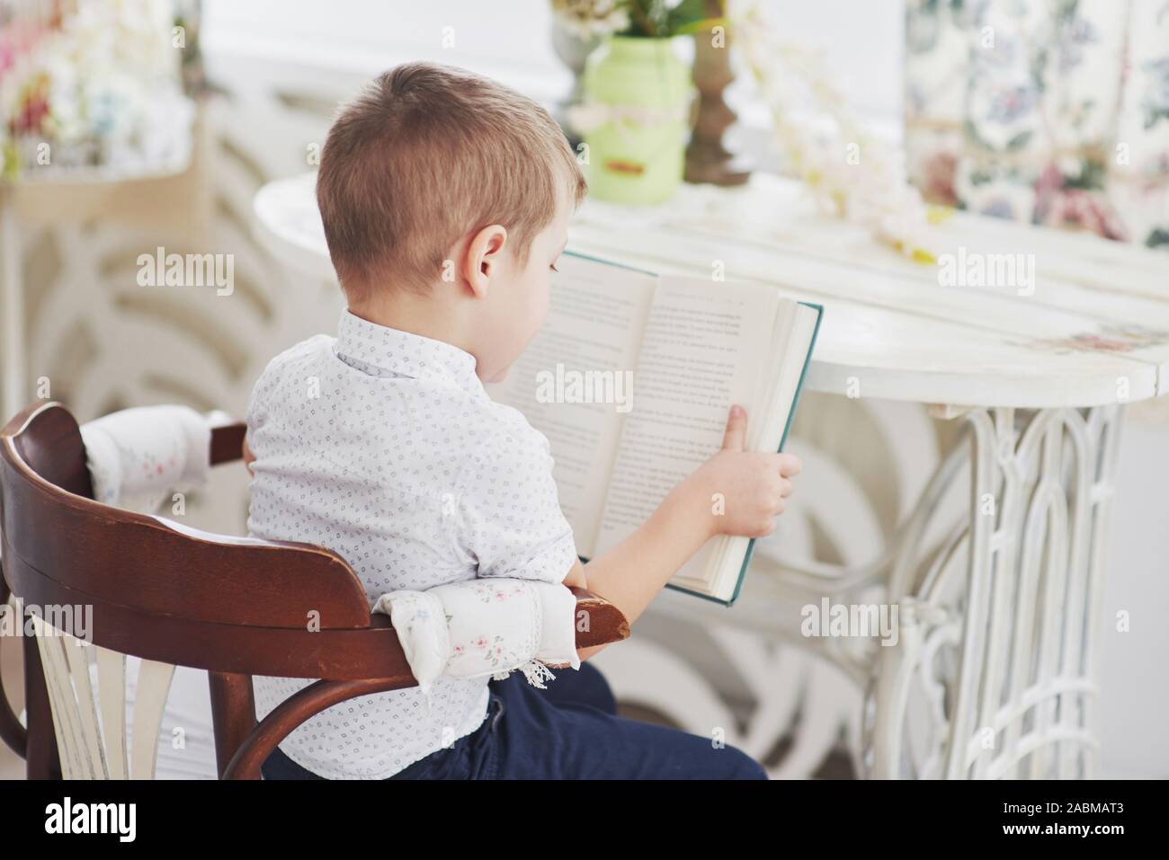 Boy reading a book. Getting ready for school Stock Photo - Alamy