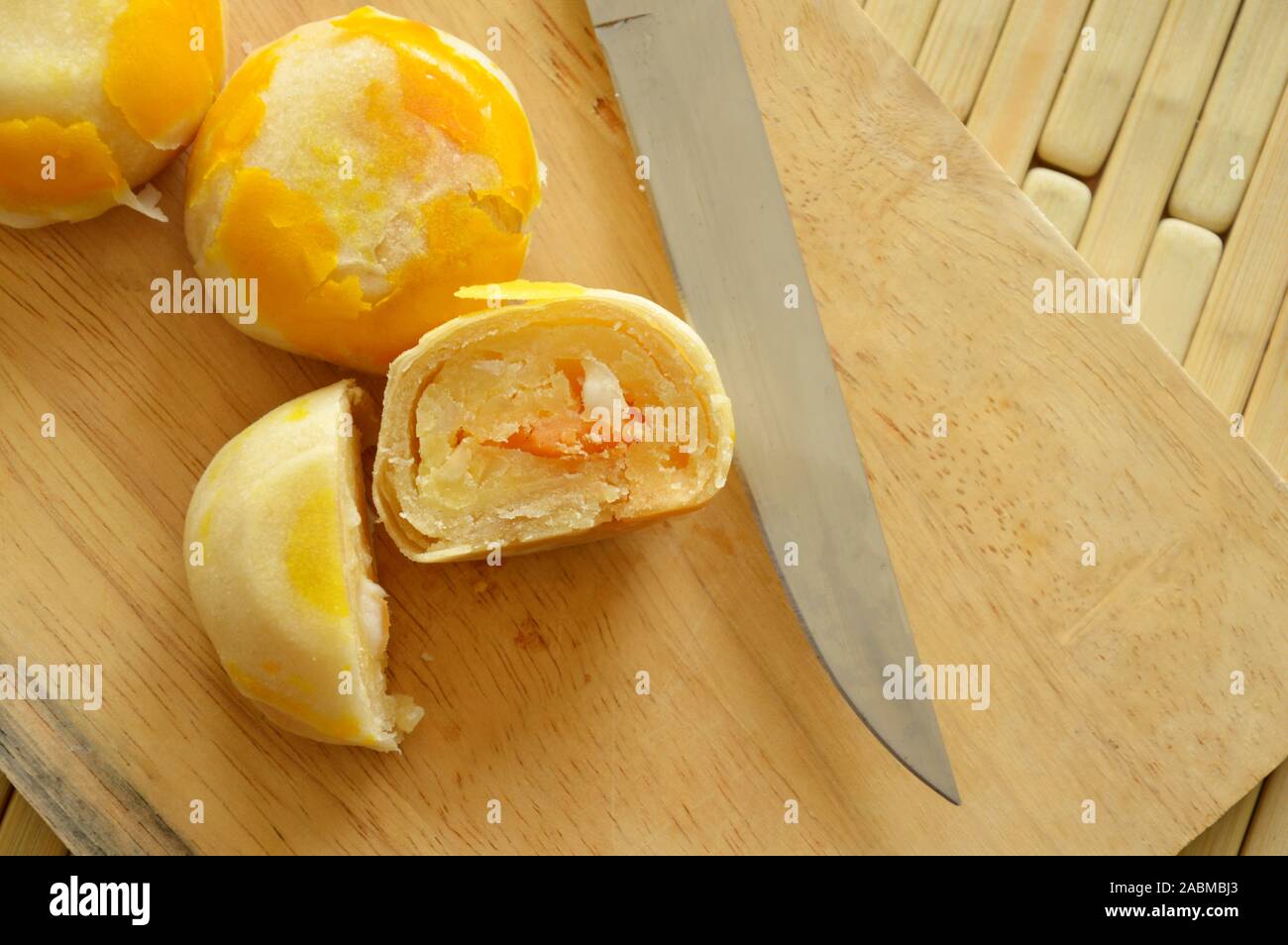 Chinese pastry filled mashed bean and salty egg yolk on wooden chop ...