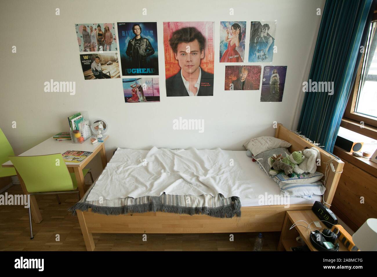 Poster on the wall above a bed of a patient room inhabited by two girls ...
